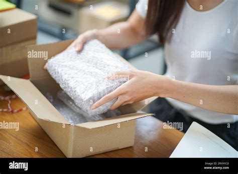 Asian Woman Preparing Package Delivery Box Shipping For Shopping Online