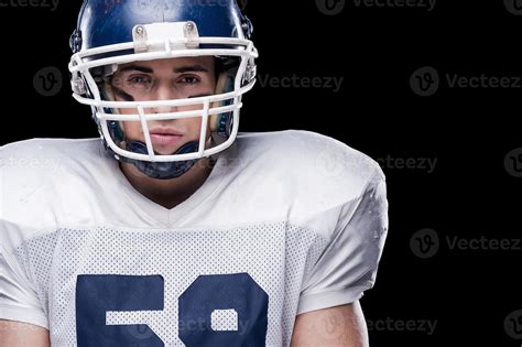 Strong And Concentrated American Football Player Looking At Camera