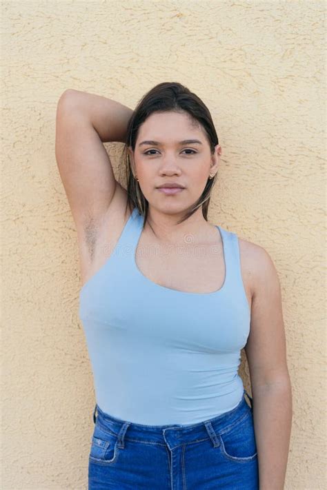 Hispanic Woman With Unshaven Armpits Confidently Looking At The Camera