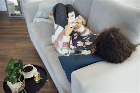 Back View Of African American Millennial Woman Holding Smartphone Stock