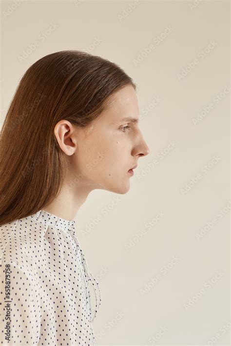 Side View Of Handsome Gender Neutral Model With Long Hair Wearing