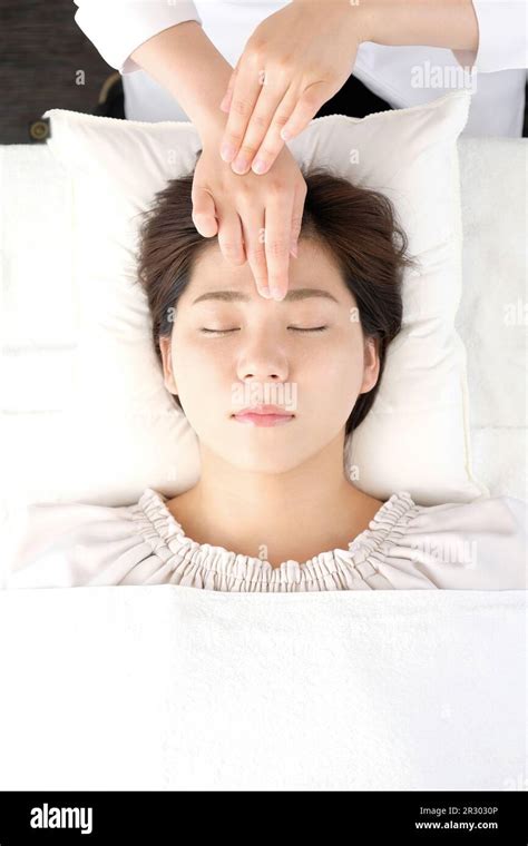 Woman Receiving Acupressure Between The Eyes At An Acupuncture Clinic