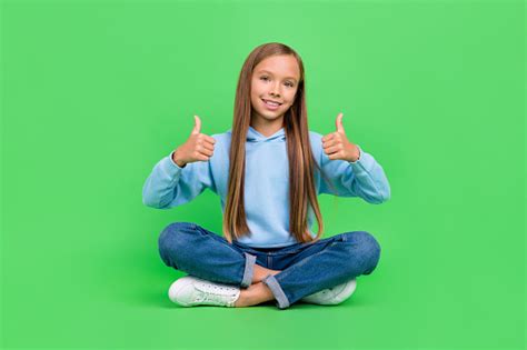 작은 동공 소녀의 전신 사진 쇼 더블 엄지 손가락 승인 기호 드레스 세련된 파란색 스포츠웨어 녹색 배경에 고립 8 9 살에 대한