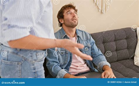 Angry Mother And Son Locked In Heated Argument On Living Room Sofa