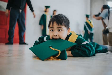 귀여운 아기 소년 물린 모자 동안 교육 가운을 입고 바닥에 앉아 아이에 대한 스톡 사진 및 기타 이미지 아이 졸업식 소년 Istock
