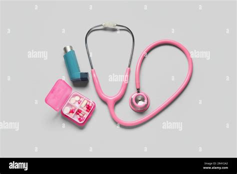 Composition With Asthma Inhaler Stethoscope And Box Of Pills On Grey