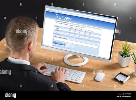 Businessman Filling Online Survey Form On Computer Stock Photo Alamy
