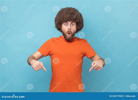 Shocked Surprised Man Pointing Down With Fore Fingers Looking At