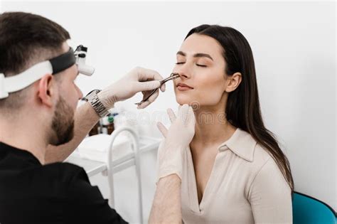 Consultation With Ent Doctor Otolaryngologist Examines Girl Nose