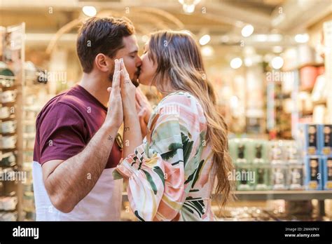 Affectionate Man And Woman Kissing Each Other In Store Stock Photo Alamy