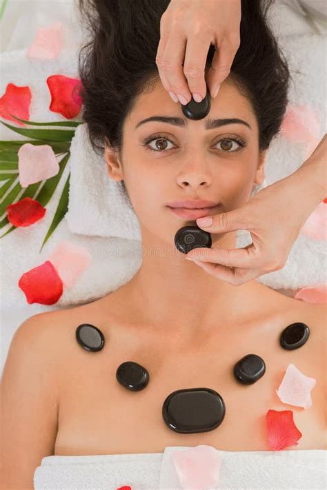 Beautician Make Stone Massage Spa For Woman At Wellness Center Stock
