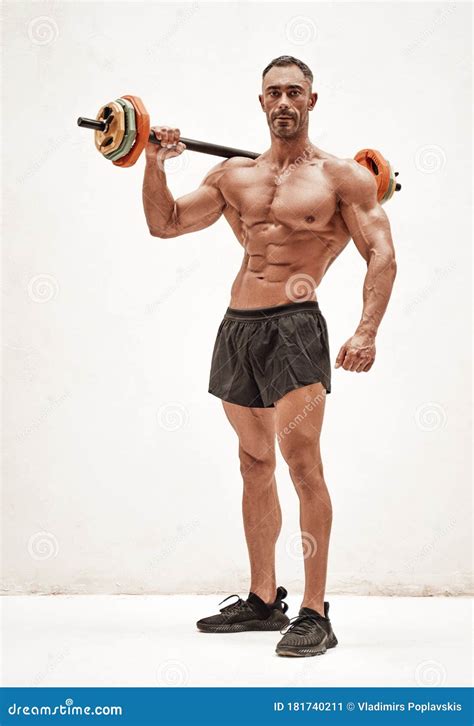 Shirtless Adult Male Bodybuilder Doing An Exercise With A Barbell In A