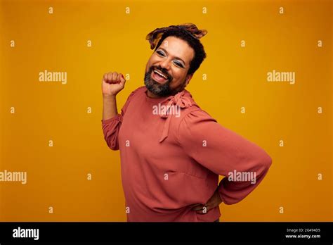 Gender Fluid Male Posing On Yellow Background Man Wearing Makeup And