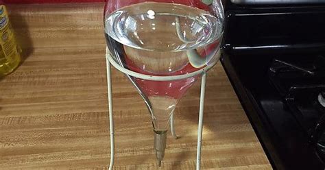 Strange Flask Bottle With Bottom Dispenser Where You Push Up On A Pin