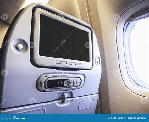 Airplane Monitor Behind Passenger Seat With Sun Light Through From The
