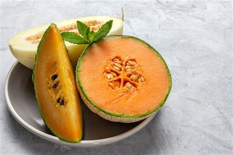 Premium Photo Fresh Assortment Melon With Mint On Gray