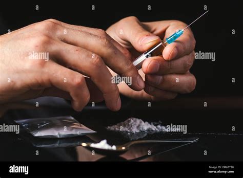 Drug Syringe In Hand A Drug Addict With Another Dose Of The Drug In