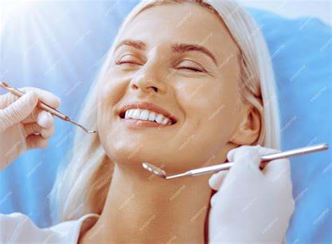 Premium Photo Smiling Blonde Woman Examined By Dentist At Dental