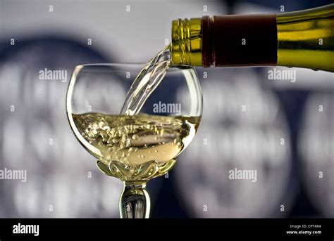 Riesling Pouring Glass Of White Rhine Wine Into Traditional Ornate Long
