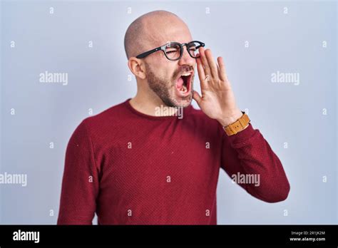 Young Bald Man With Beard Standing Over White Background Wearing