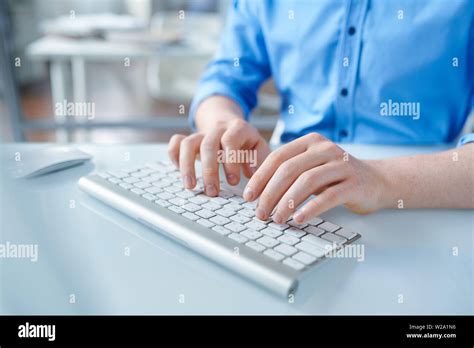 Creative Designer In Blue Shirt Touching Buttons Of Computer Keypad