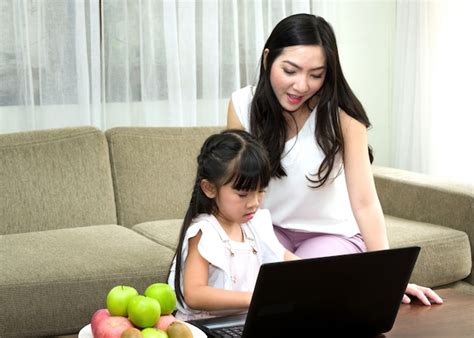 Premium Photo Asian Mom Is Teaching Their Daughter To Type The