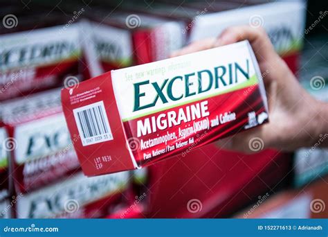 Shoppers Hand Holding A Box Of Excedrin Brand Genuine Migraine