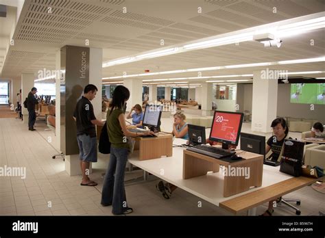 People Looking At Public Computer Terminals In State Library In