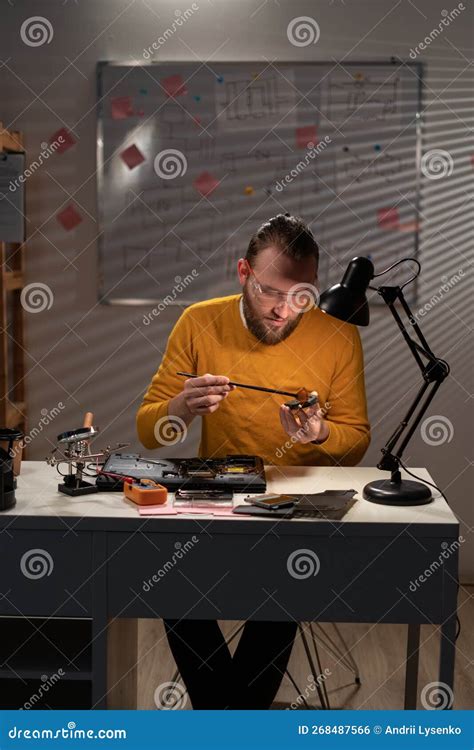 Man Disassembling A Notebook And Cleaning Its Cooling System Dirt On