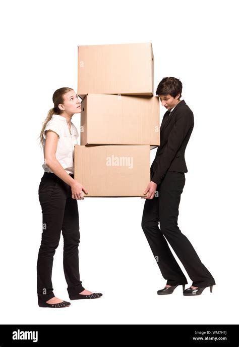 Two Women Carrying Three Boxes Stock Photo Alamy