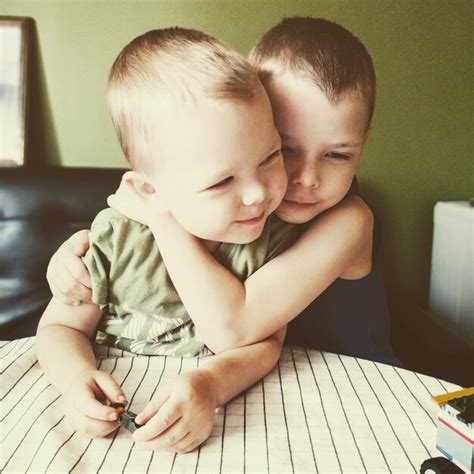 Premium Photo Boy Embracing Brother At Table