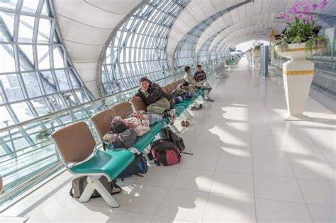 Passengers Wait At The Departure Gate For The Boarding Call Of Their