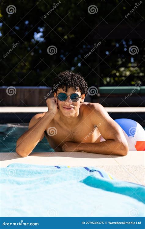 Portrait Of Biracial Shirtless Young Man In Sunglasses With Hand On