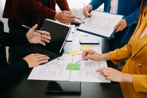 Premium Photo Ux Developer And Ui Designer Brainstorming About Mobile