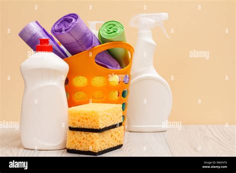 Plastic Bottles Of Glass And Tile Cleaner Basket With Garbage Bags
