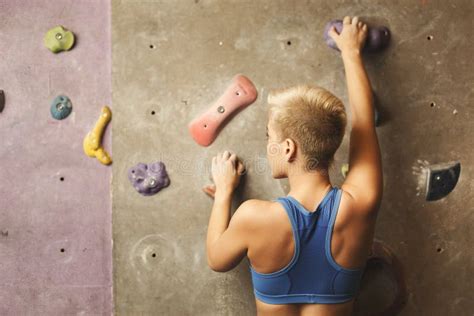 Young Woman Climbing Artificial Rock Wall At Gym Stock Image Image Of