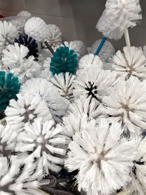 Different Types Of Cleaning Brushes Arranged In A Storage Container