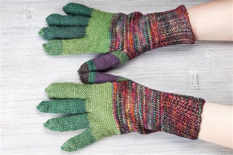 Premium Photo Back View Of Hands In Knitted Gloves On Gray