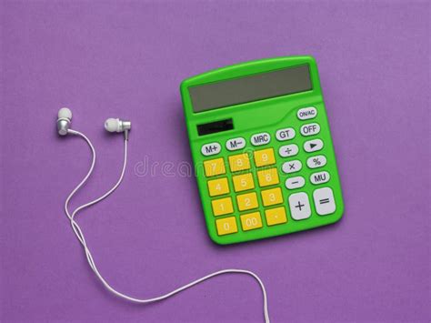 Yellow Green Calculator And White Headphones On A Purple Background