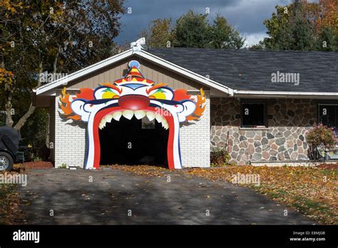 Scary Frightening Huge Clown Face With Teeth Covering The Entrance To A