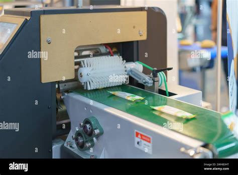 Close Up Image Capturing An Automated Packaging Machine In Operation Sealing Snack Packets On A