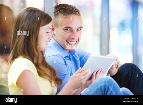Smiling Couple Having Fun With Digital Tablet In Shopping Centre Stock