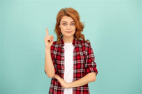 Premium Photo Inspired Redhead Girl In Checkered Shirt On Blue Background