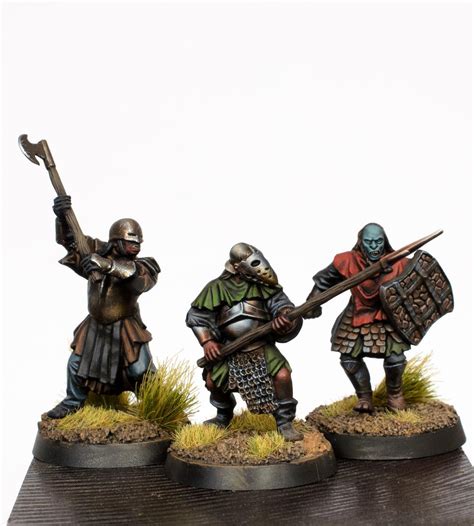 Three Mordor Orcs The One On The Left Is Painted With Metallic Paints