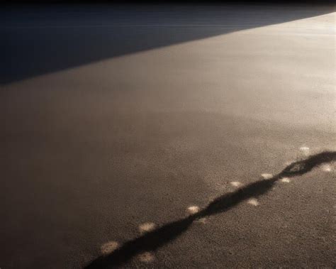 Premium Ai Image A Shadow Of A Pole And A Street Light On A Street