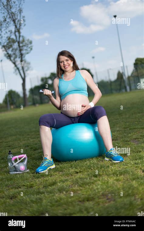 Beautiful Young Pregnant Woman Exercises With Fitball In The Gym Stock
