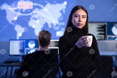 Professional Female It Consultant Holding Coffee Cup In Large Cyber Security Operations Center