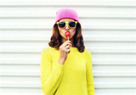 Portrait Fashion Pretty Cool Girl Sucking Lollipop In Colorful Clothes