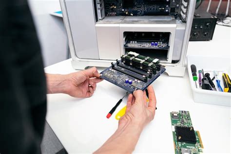 Premium Photo Expert Hands Fixing A RAM On A Motherboard