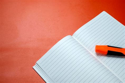 Premium Photo A Notebook Is Open On A Red Table